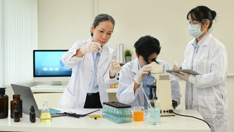 Team of Professional Scientists Conducting Experiment in Laboratory for ... Team of Professional Scientists Conducting Experiment in Laboratory for ...