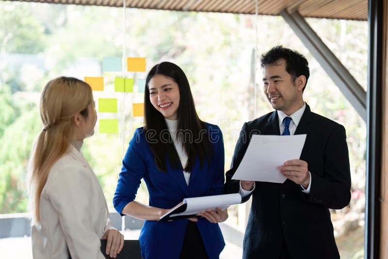 Team Business Professionals Discussing Strategies Sharing Documents ...