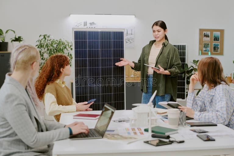 Discussing Renewable Energy with Diverse Team in Office Setting Stock ...