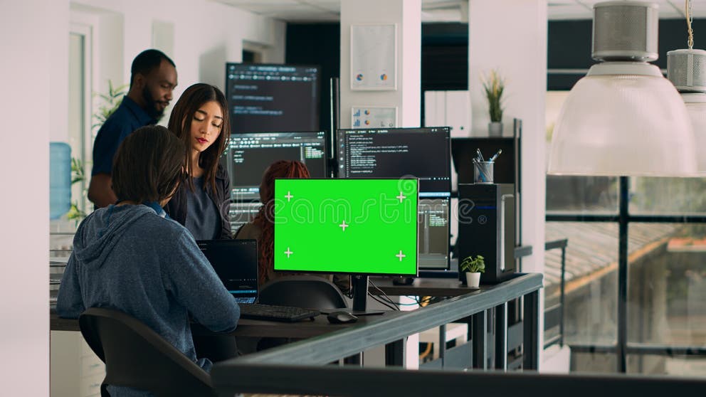 Team Of Programmers Working On Source Code With Greenscreen Monitor