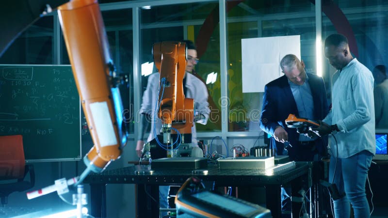 Team of Researchers are Working with Robots in a Science Lab Stock ...