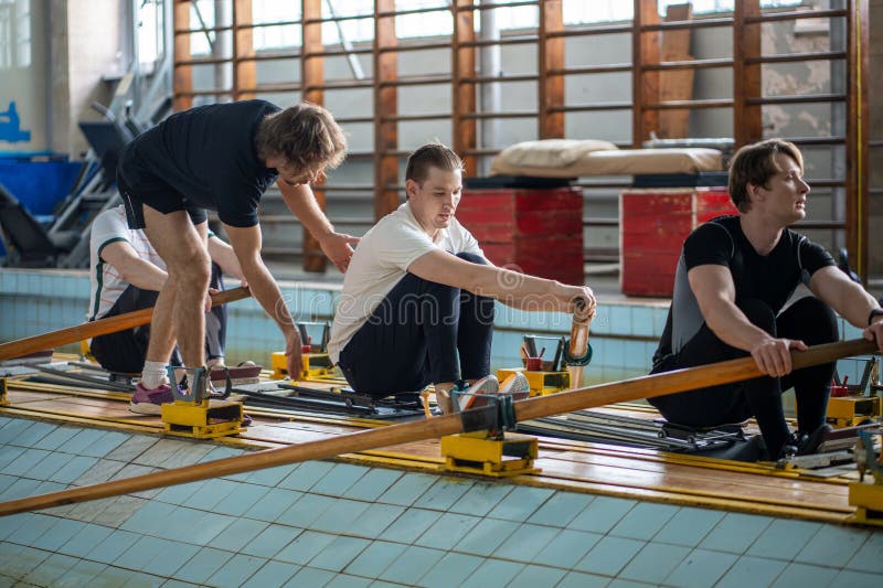 Struggling Grimacing Sportsmen Exert on Rowing Simulator, Paddling ...