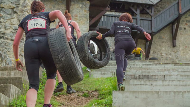 A Man Running with Tire in His Hand through Obstacle Course Stock Video ...