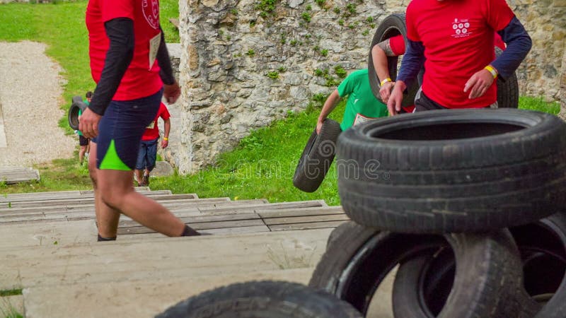 A Man Running with Tire in His Hand through Obstacle Course Stock Video ...