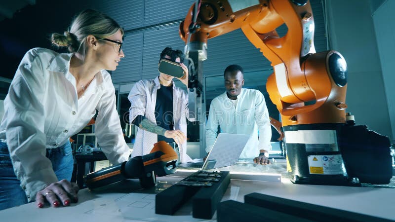 Team of Science Workers are Using VR-glasses To Manage a Robot. Team ...