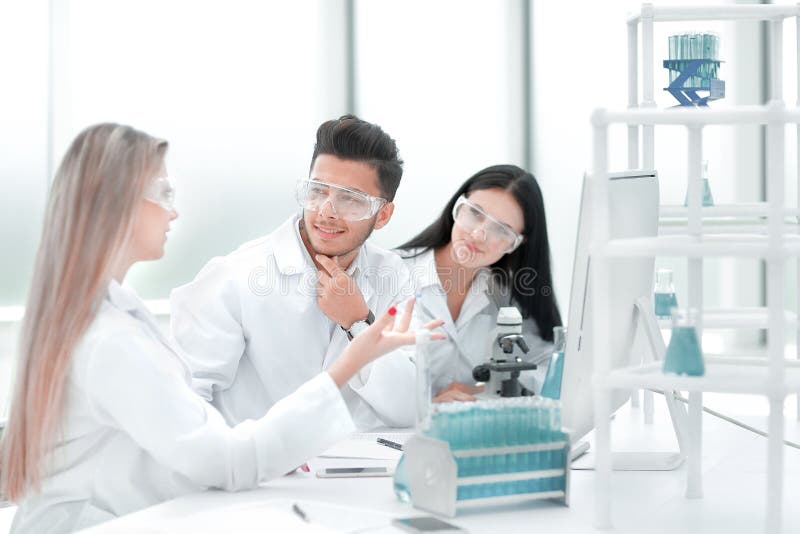 Team of Scientists Discussing Something at the Desk Stock Photo - Image ... Team of Scientists Discussing Something at the Desk Stock Photo - Image ...