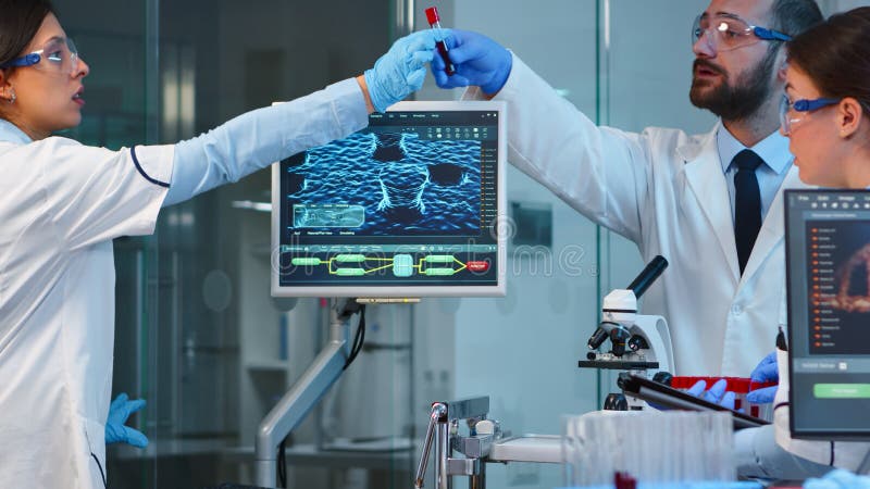 Team of Scientists Doing Biological Researches Under Microscope Stock ...