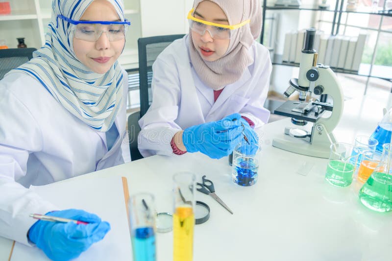 Scientists Doing Research and Analysis with Microscope Stock Photo ...