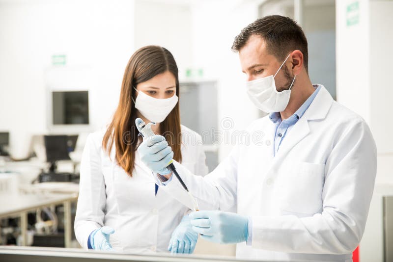 Team of Scientists Doing Some Work in a Lab Stock Photo - Image of ...