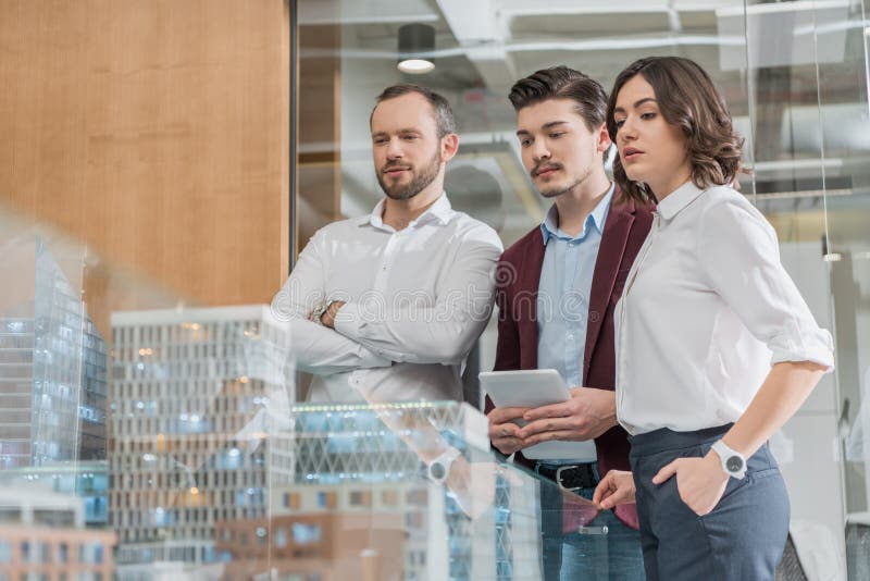 Team of Serious Architects Looking at Miniature Stock Photo - Image of ...