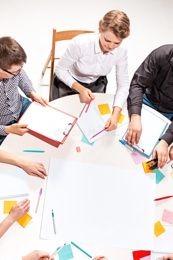 Team Sitting Behind Desk, Checking Reports, Talking. Stock Photo ...