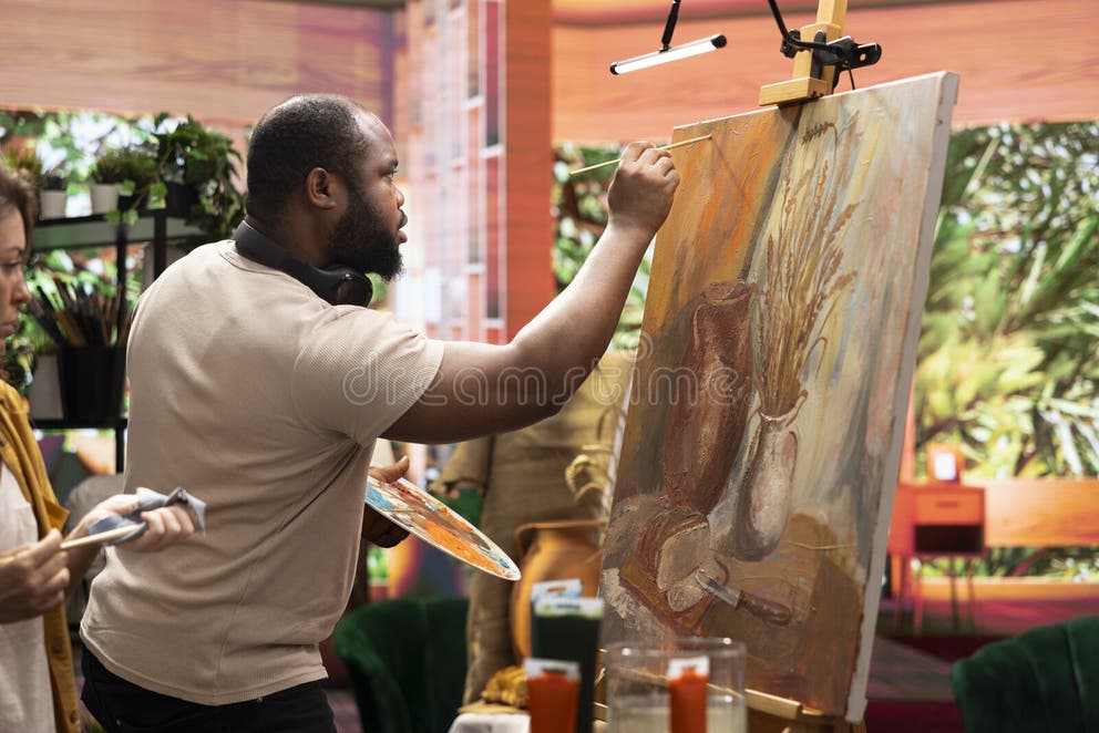 Team of Skilled Artist Collaborating on a Rustic Painting in Art Studio ...