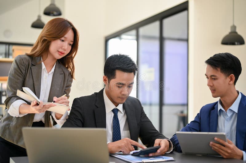 A Team of Smart Asian Financial Analysts Brainstorming, Discussing Plan ...