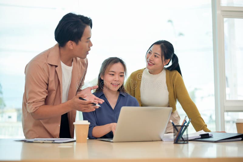 A Team of Smart Young Employees Focused on Discussing Work, Sharing ...