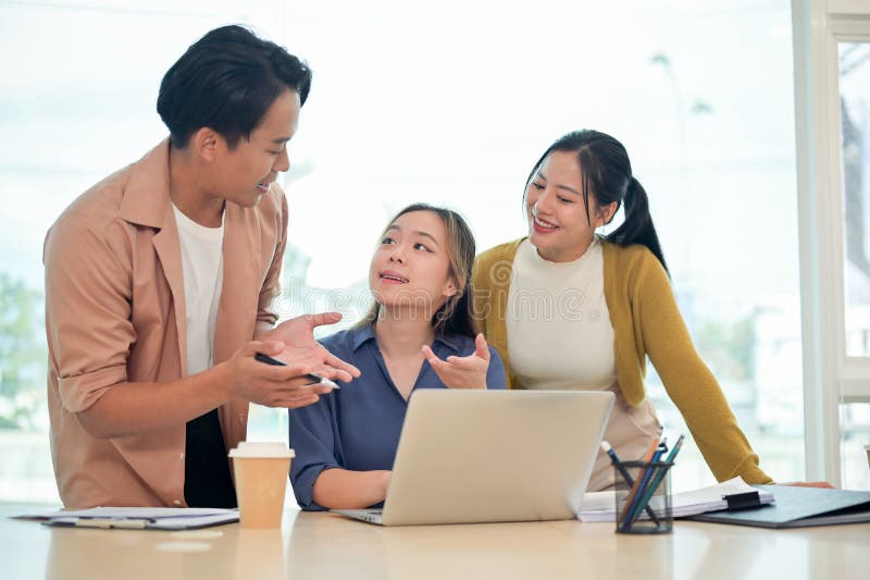 A Team of Smart Young Employees Focused on Discussing Work, Sharing ...