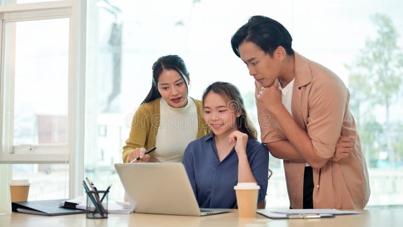 A Team of Smart Young Employees Focused on Discussing Work, Sharing ...