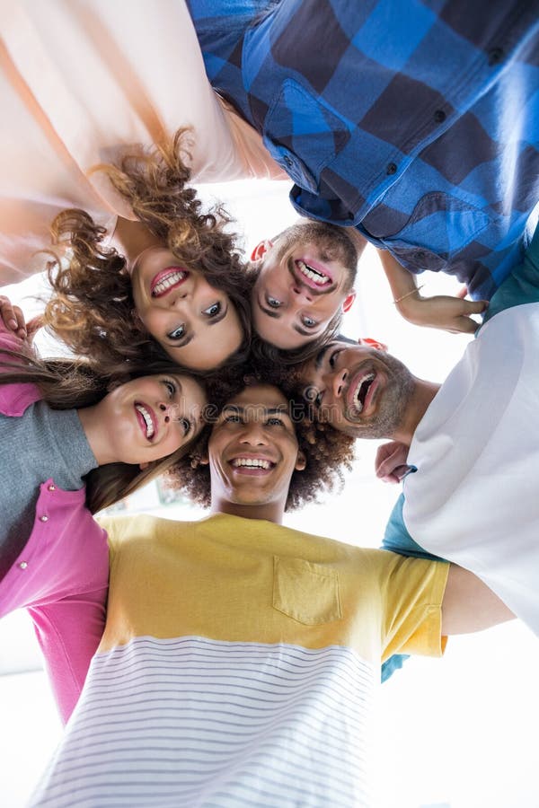 Team of Smiling Executives Forming Huddle Stock Image - Image of ...