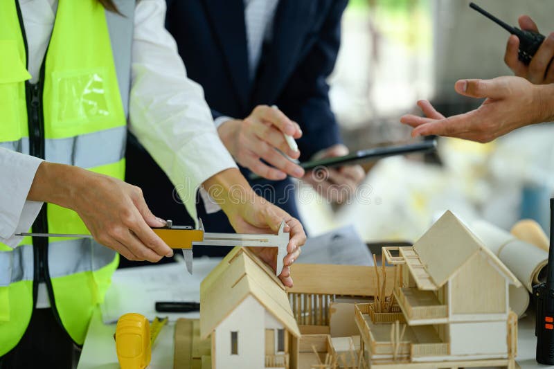 Team of Specialists Discussing the Structure of the Building at ...