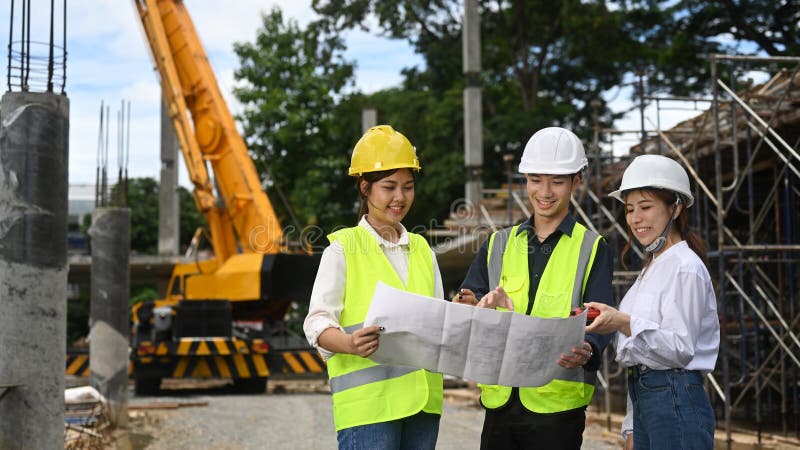 Team of Specialists Inspecting, Discussing Plan Details with Civil ...
