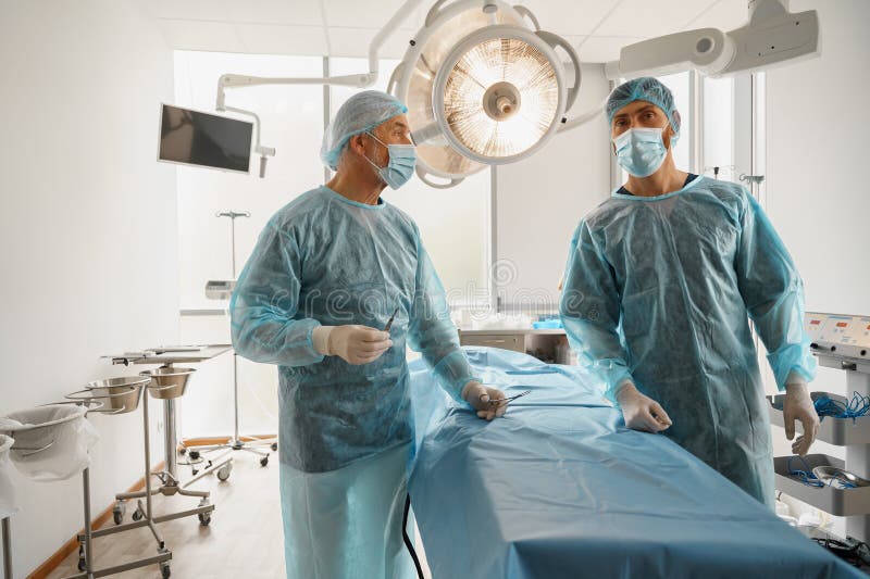Team of Surgeons in the Operating Room Ready for Surgery in Clinic ...