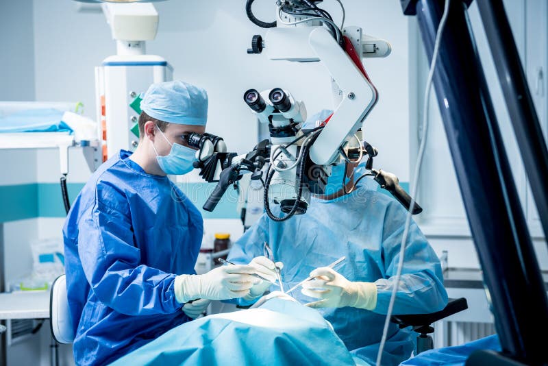 A Team of Surgeons Performing Brain Surgery To Remove a Tumor. Stock ...