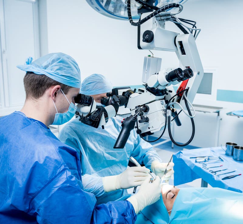 A Team of Surgeons Performing Brain Surgery To Remove a Tumor. Stock ...