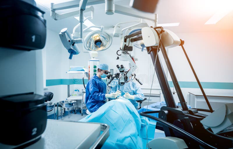 A Team of Surgeons Performing Brain Surgery To Remove a Tumor. Stock ...