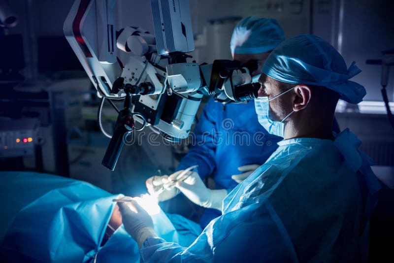 A Team of Surgeons Performing Brain Surgery To Remove a Tumor. Stock ...