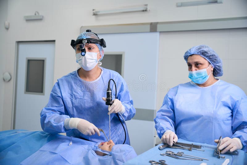 Team of Surgeons Working in a Sterile Operating Room Stock Photo ...