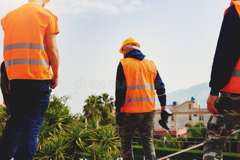 Team of Technical Workers Work on the Roof of a House Stock Photo ...