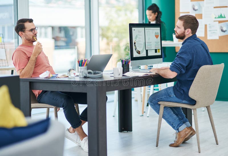 The Team Thats Owning the Design Game. Two Young Businessmen Using ...