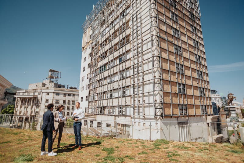 Team of Three Architects Discussing Progress of Building Stock Image ...