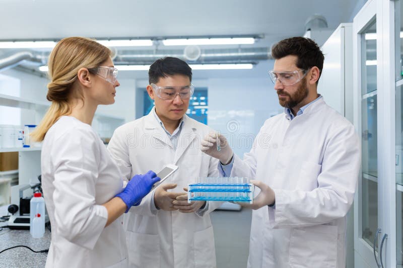 A Team of Three People, Doctors, Laboratory Workers, Scientists are ...