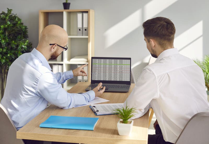 Team of Two Accountants Using Laptop Computer and Working with Business ...