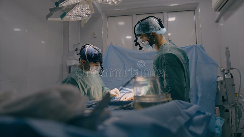 Team of Two Doctors Men Surgeons Processing Surgical Operation Using ...