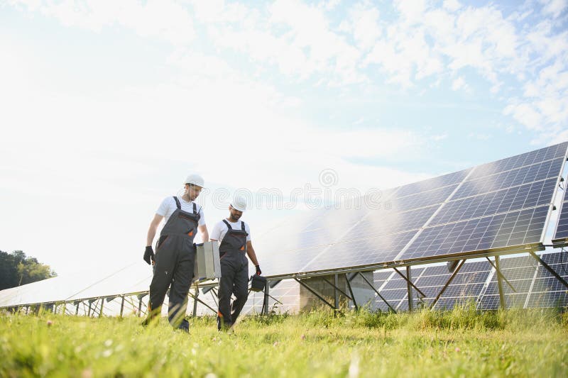 A Team of Two Engineers are Working To Install Solar Panels at a Solar ...