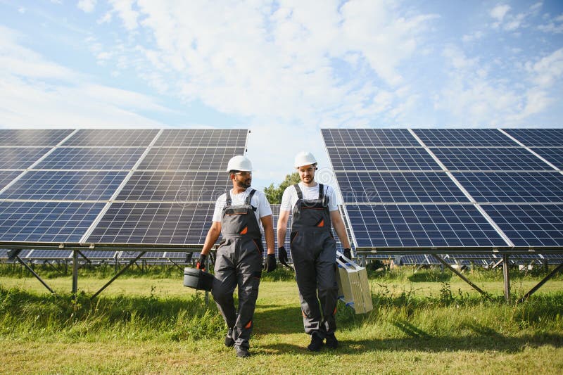 A Team of Two Engineers are Working To Install Solar Panels at a Solar ...