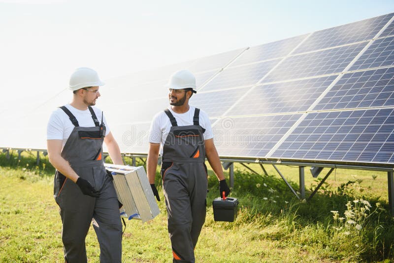 A Team of Two Engineers are Working To Install Solar Panels at a Solar ...