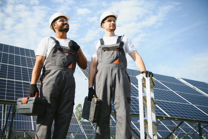 A Team of Two Engineers are Working To Install Solar Panels at a Solar ...