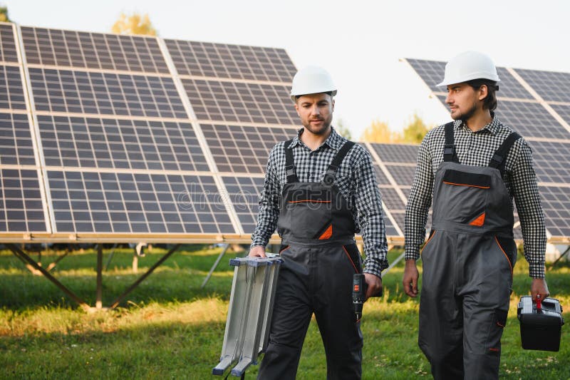 A Team of Two Engineers are Working To Install Solar Panels at a Solar ...