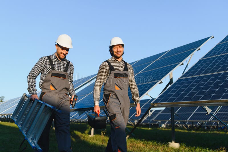A Team of Two Engineers are Working To Install Solar Panels at a Solar ...
