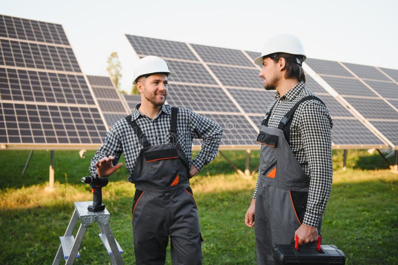 A Team of Two Engineers are Working To Install Solar Panels at a Solar ...