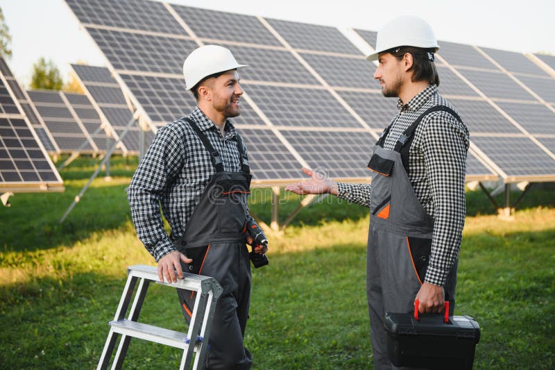 A Team of Two Engineers are Working To Install Solar Panels at a Solar ...