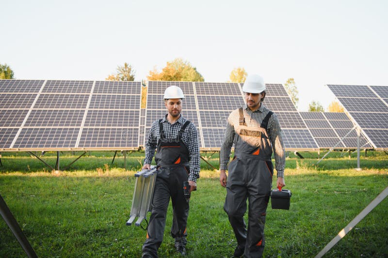A Team of Two Engineers are Working To Install Solar Panels at a Solar ...