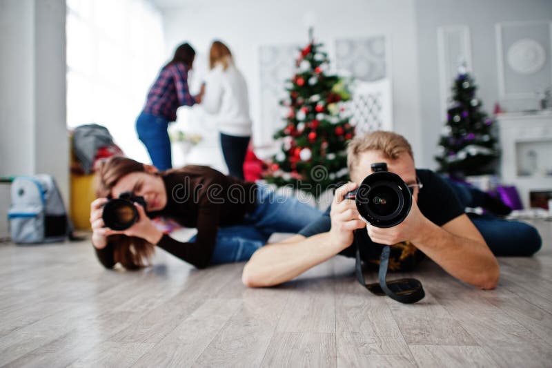 The Team of Two Photographers Lie on the Floor and Shooting on Studio ...
