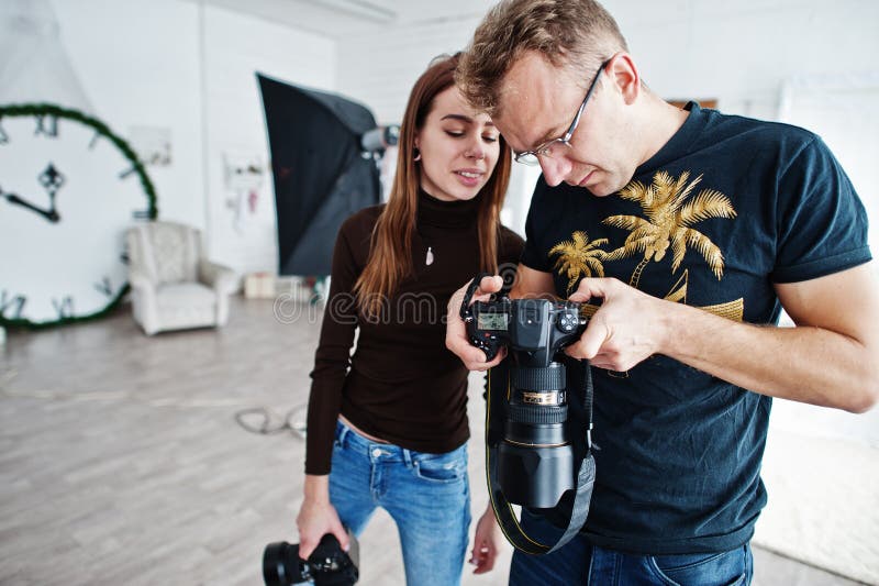 The Team of Two Photographers Looking at Camera Final Work Material on ...
