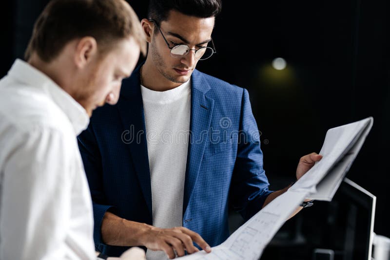 Team of Two Professional Architects Work with Sheet with Drawing in the ...