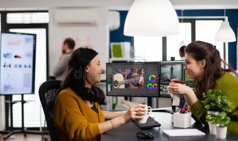 Team of Videographers Taking Work Break Discussing and Laughing Stock ...