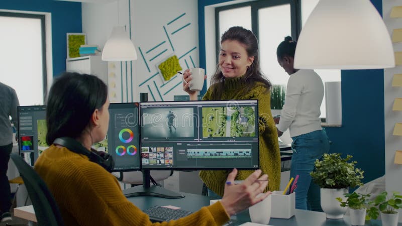 Team of Videographers Talking about Project while Working in Video ...