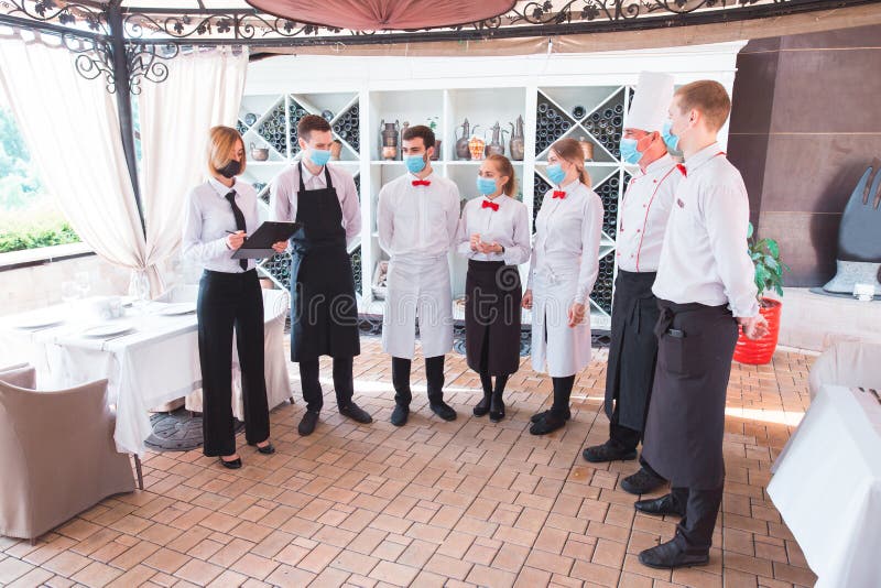 A Team of Waiters Conduct a Briefing on the Summer Terrace of the ...